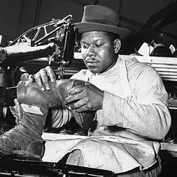 'Howard Wilson operating the sewing machine in the C. & E. Shoe Shop at ...
