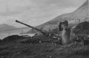 An alerted gunner in a 40 mm gun position on Alexai Point Airbase scans ...