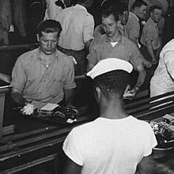 Photograph with caption 'Cafeteria Lines in Mess Hall at Naval Barracks ...