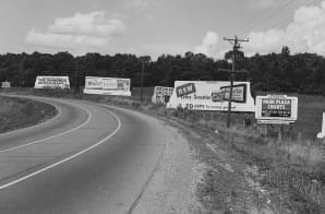 Curve in highway with assorted billboards - DocsTeach