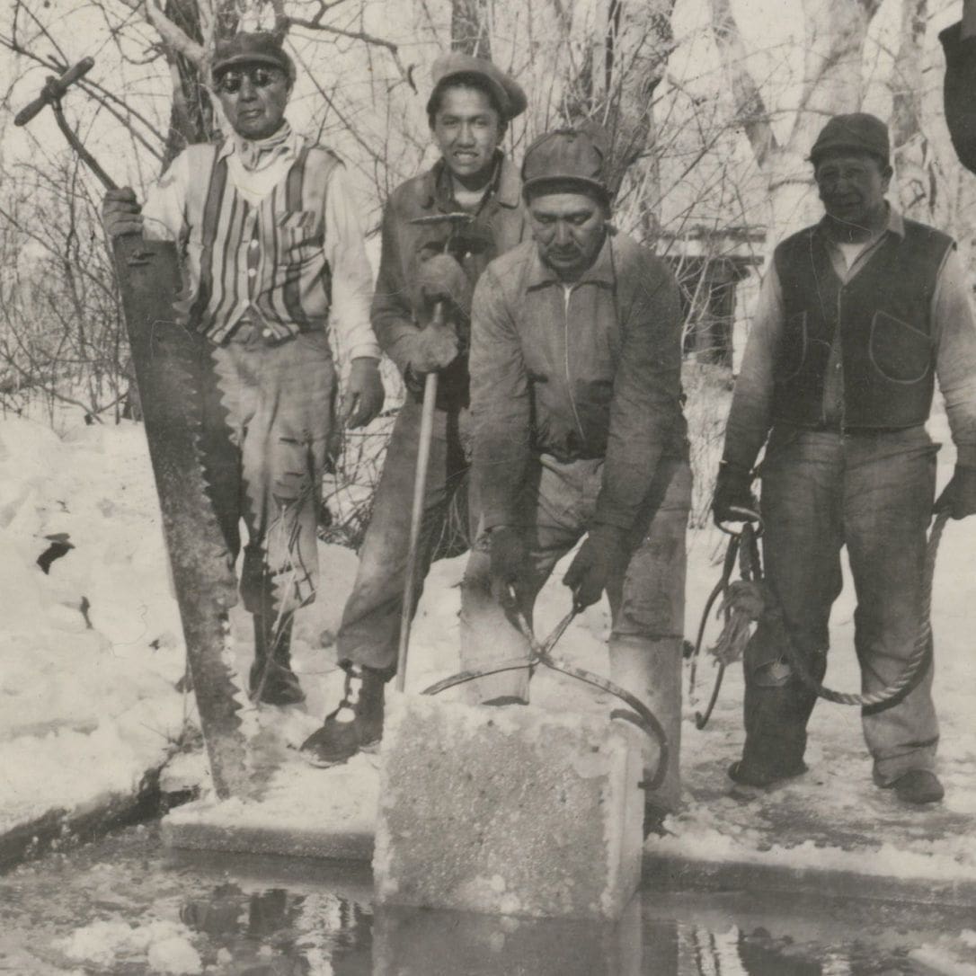Five men cut large blocks of ice from frozen lake - DocsTeach