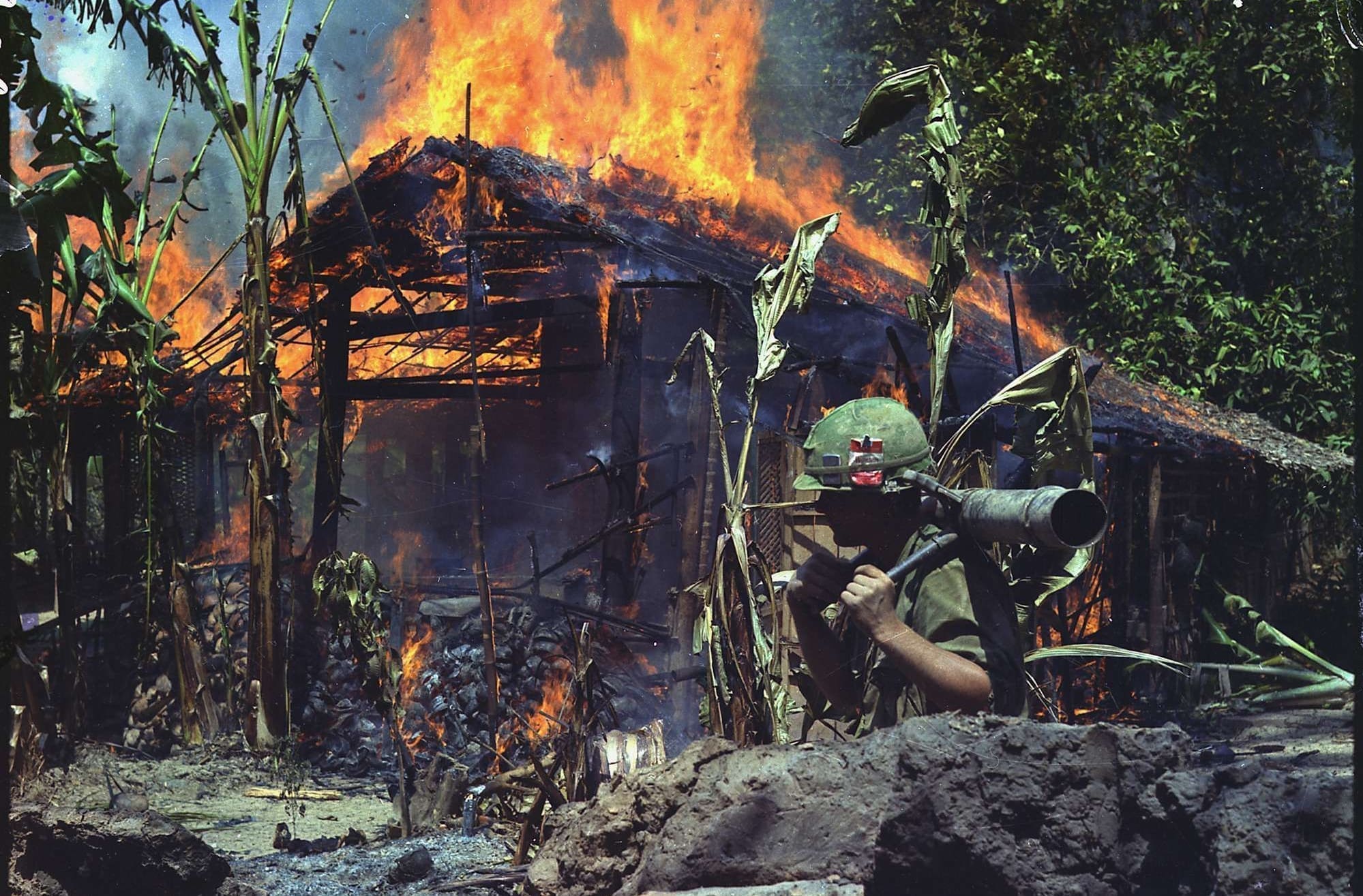My Tho, Vietnam. A Viet Cong Base Camp Burning. In the Foreground is ...