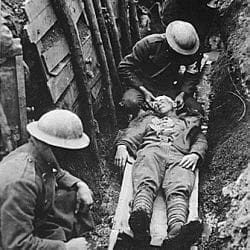 Marine receiving first aid before being sent to hospital in rear of ...